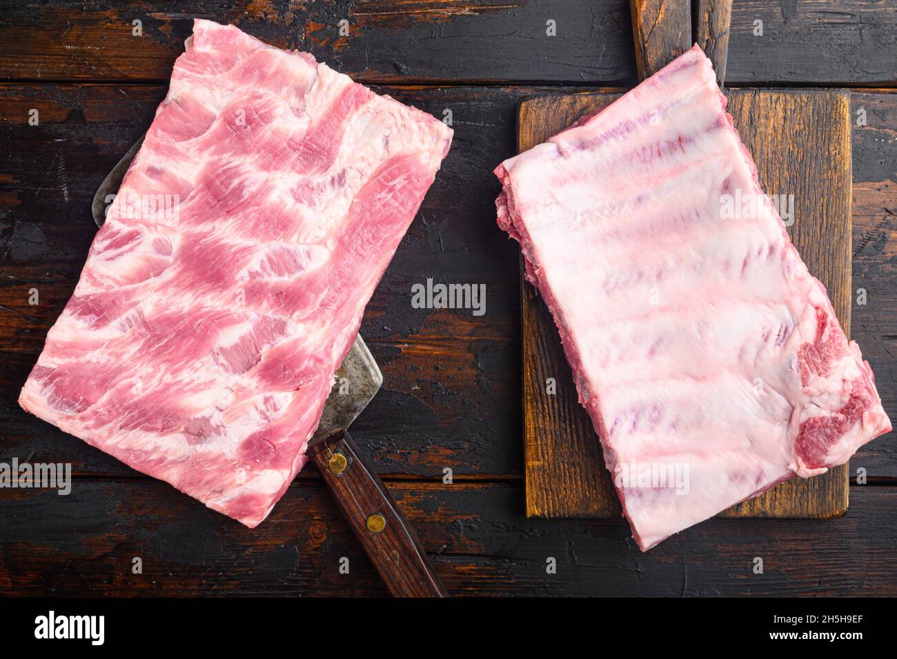 Rack of raw pork spare ribs set, on wooden cutting board, on old dark ...