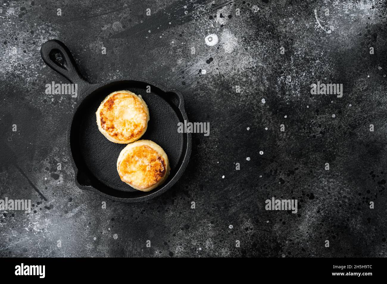 Cheese cakes Sweet pancakes set on cast iron frying pan skillet, top ...