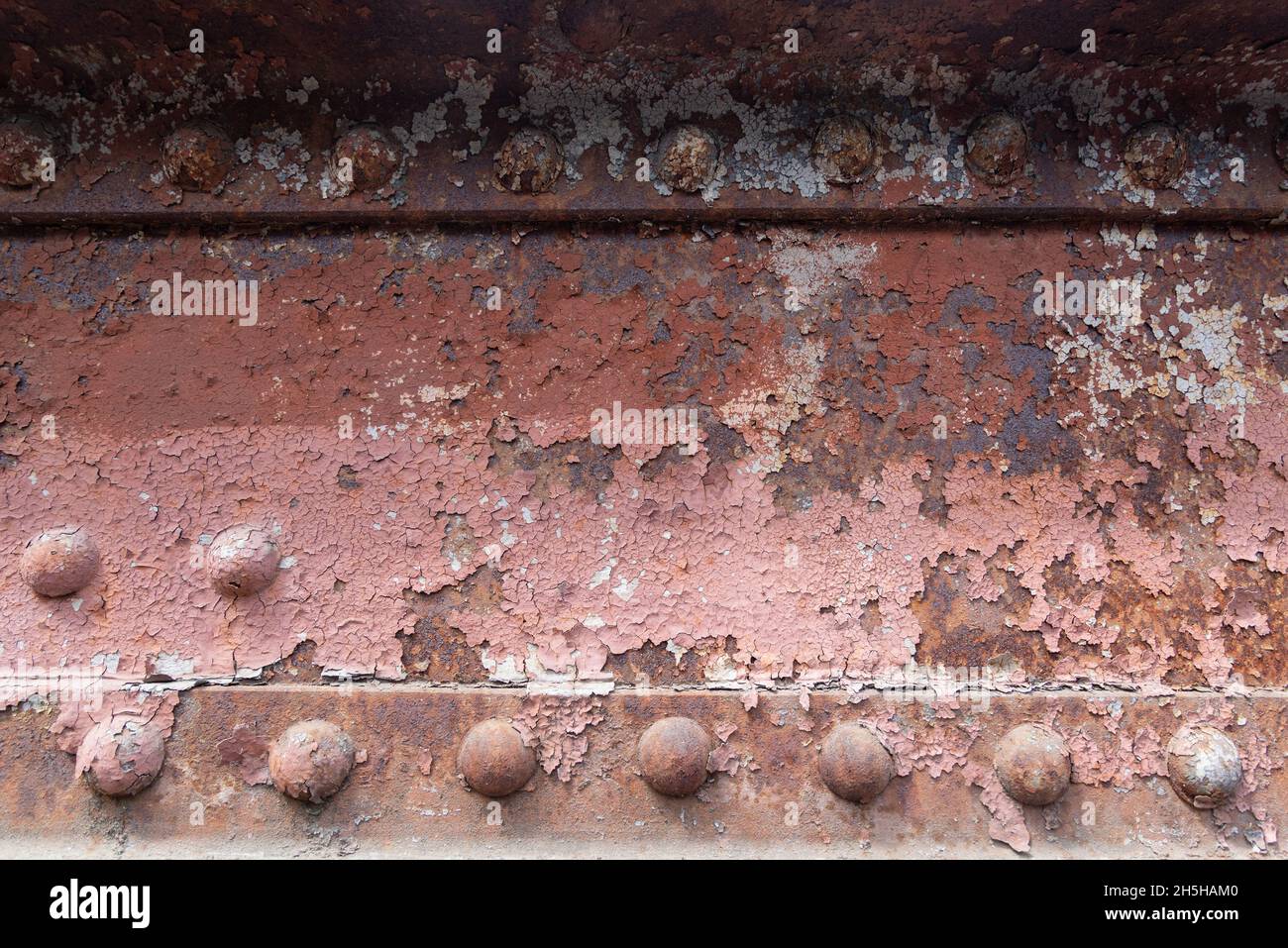flaking paint on a rusty riveted bridge. Old rivets on the bridge Stock ...