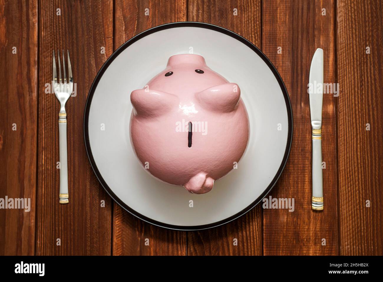 A pink piggy bank on dish. Savings consumer concept. Piggy bank on the ...