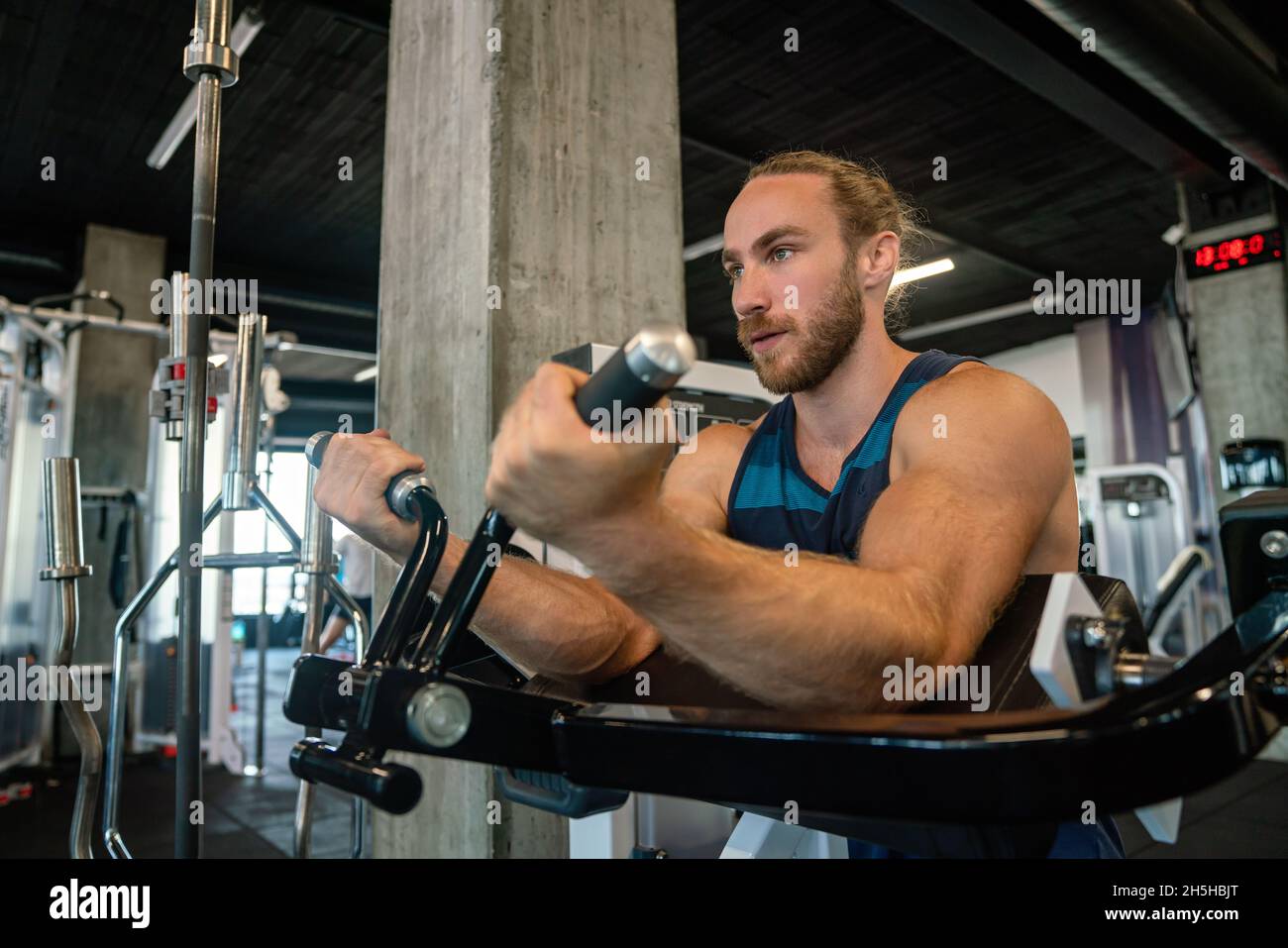 Handsome muscular man working out hard at gym Stock Photo - Alamy