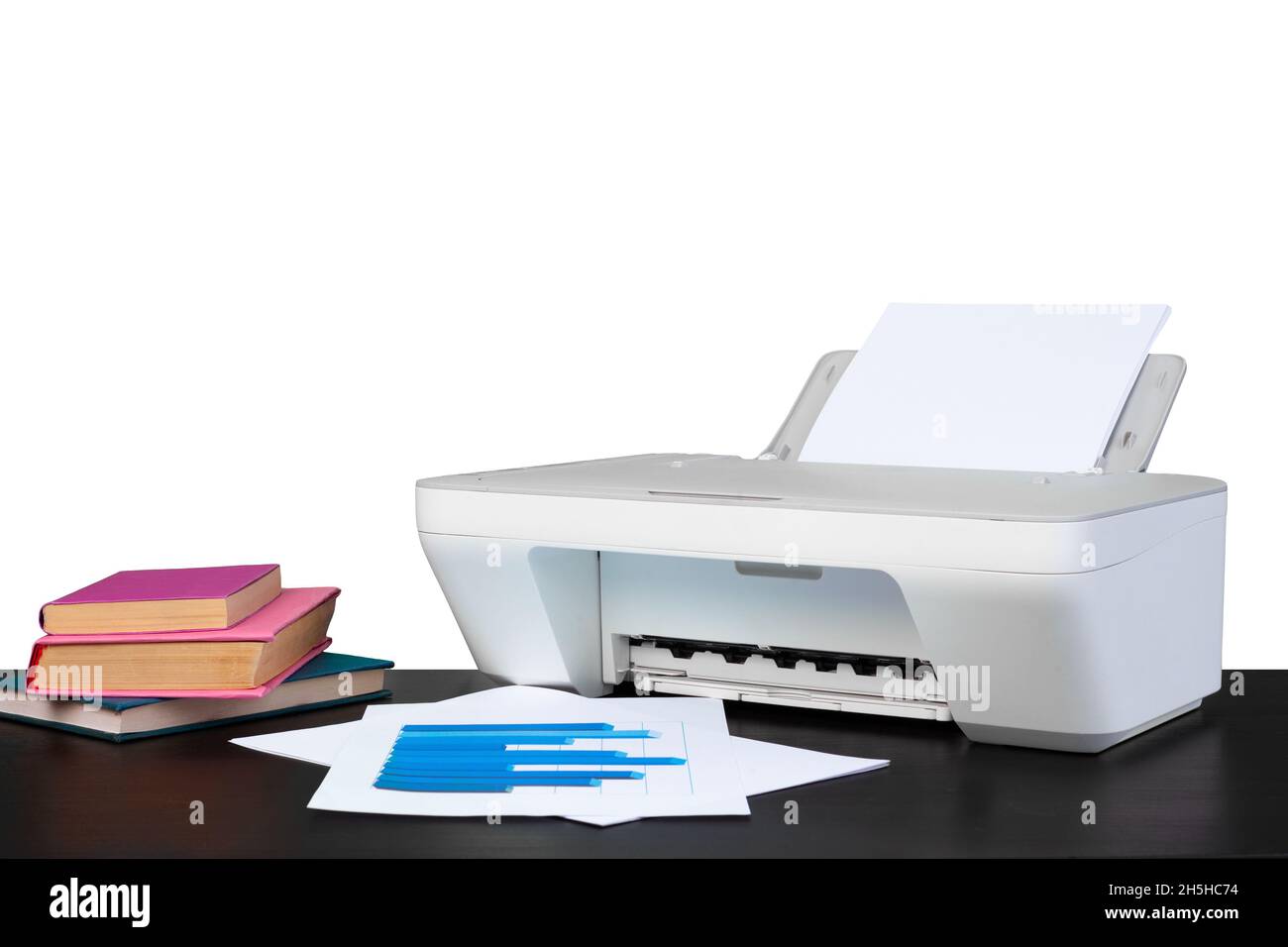 Printer and stack of books on black table against white background ...
