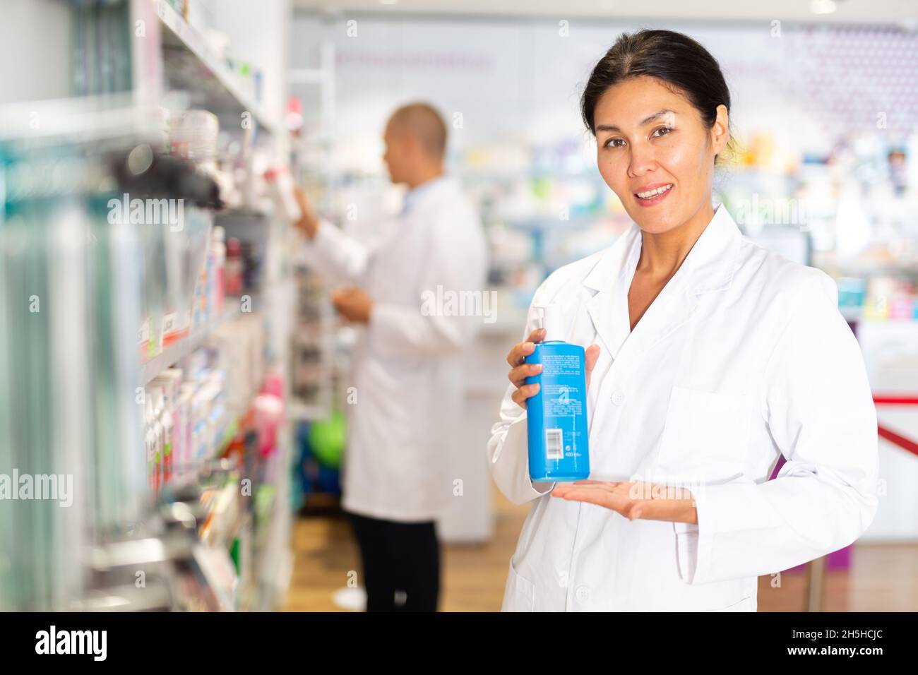 Female pharmacist offers various body care medicines Stock Photo - Alamy