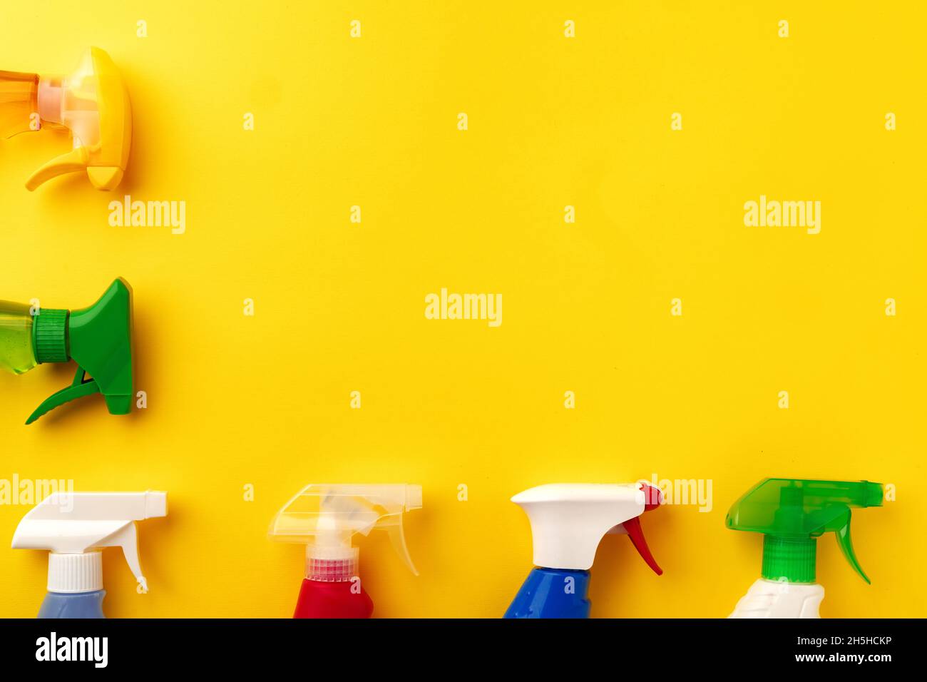 Cleaning detergent spray bottles on yellow background top view Stock ...
