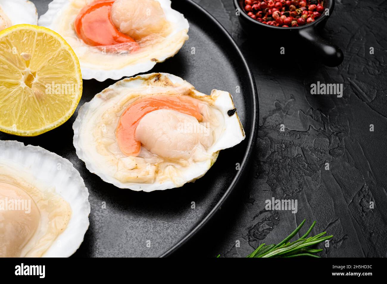 Shellfish Scallops in seashells with garlic and spices set, on black ...