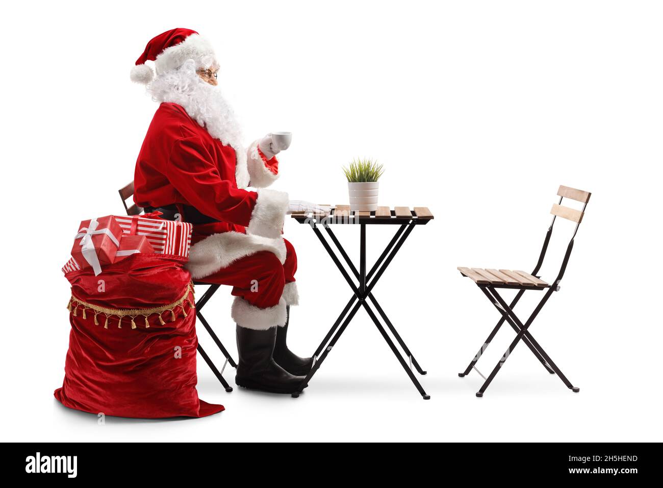 Santa Claus having a cup of coffee in a cafe isolated on white ...
