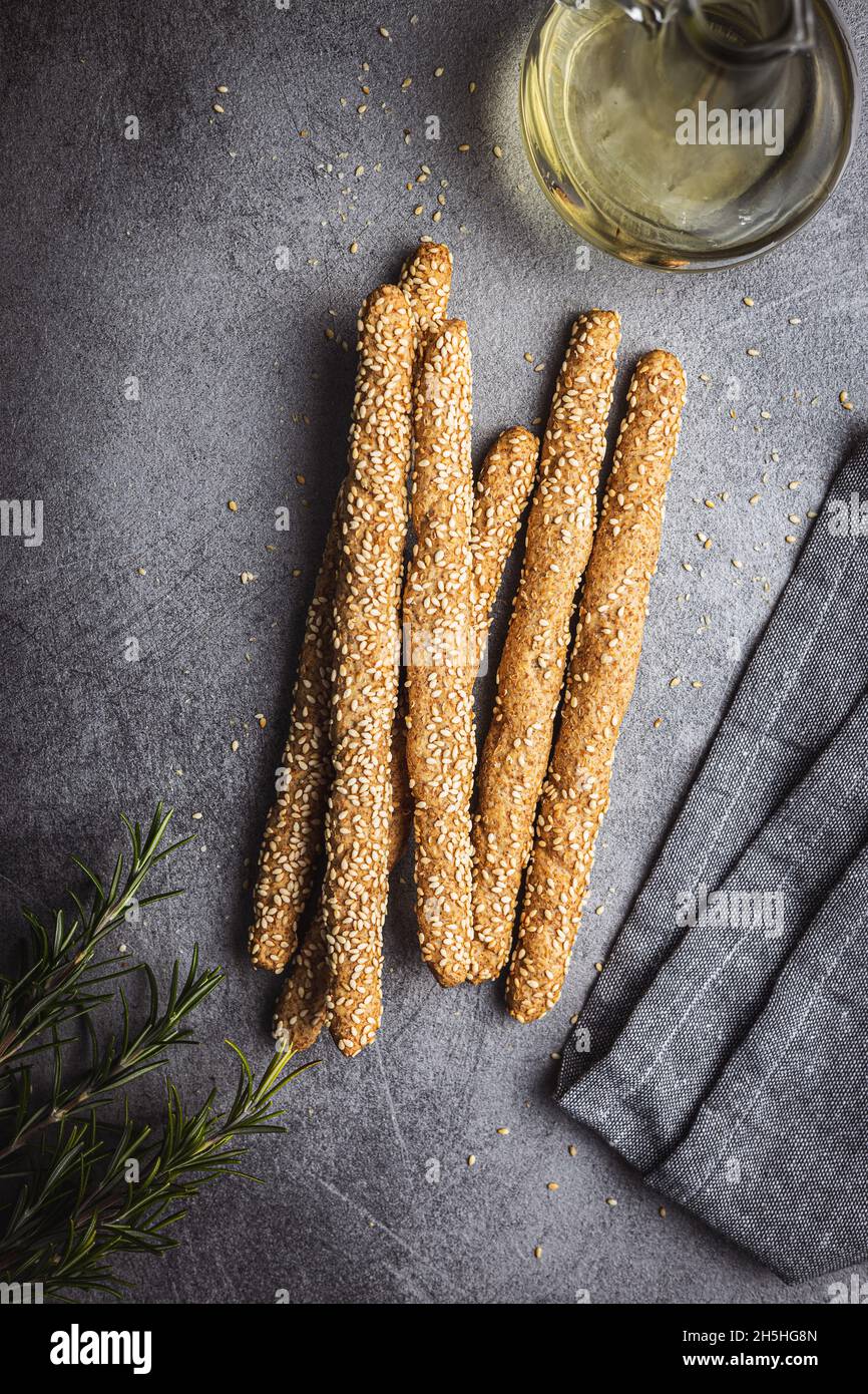 Breadsticks grissini. Bread sticks with sesame seeds on kitchen table ...