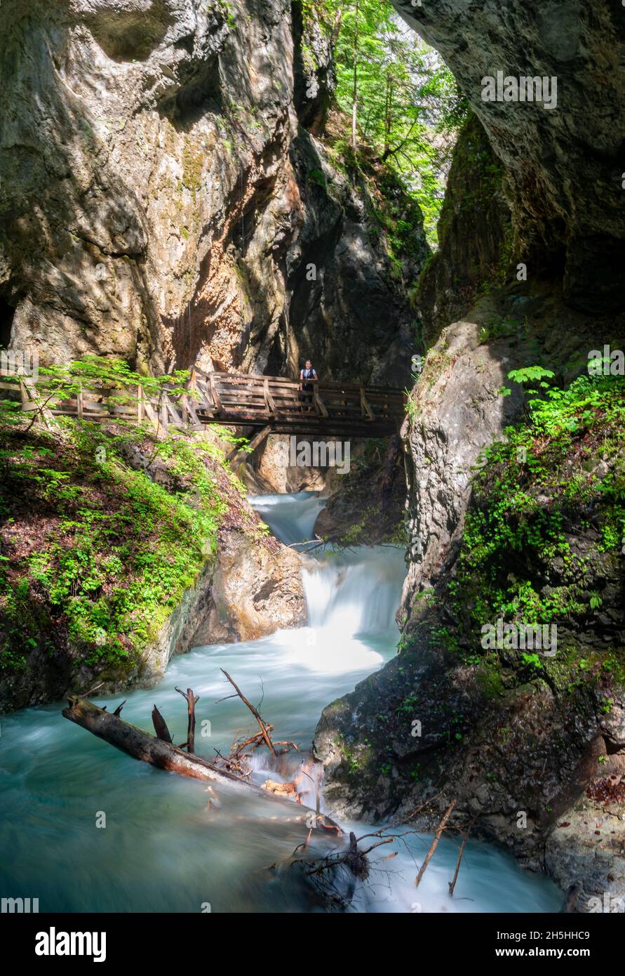Bridge over a stream, mountain stream flowing through a narrow gorge ...