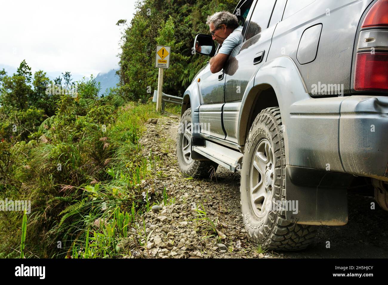 Driver checks the road in an off-road vehicle, Toyota Land Cruiser, on ...