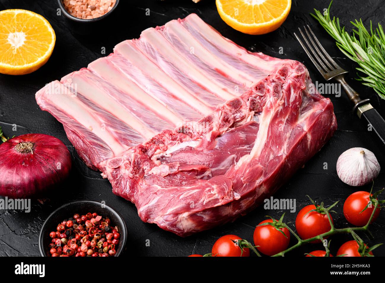 Lamb meat rib rack set, on black dark stone table background Stock ...