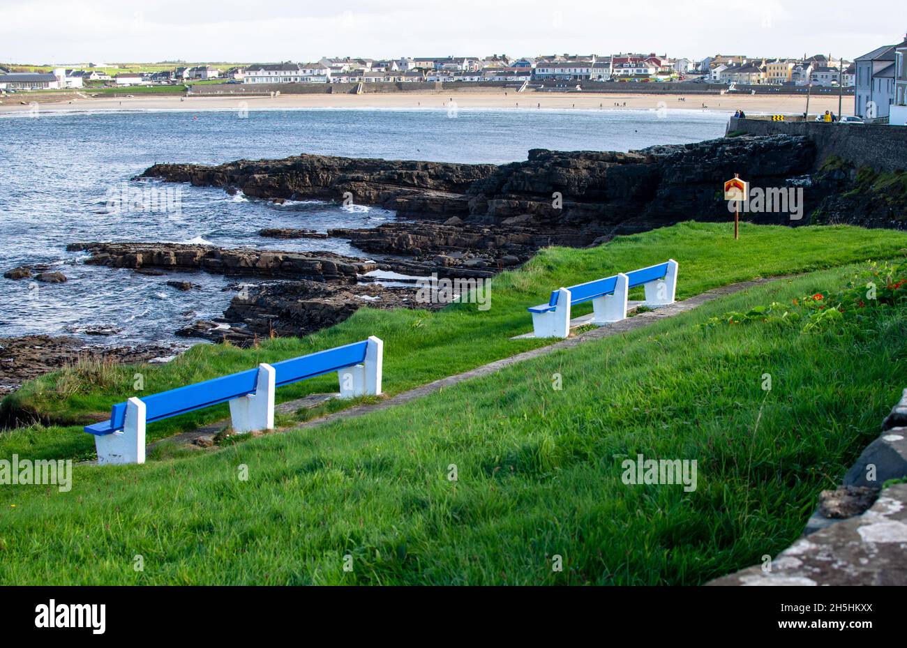 Many color (red, blue, green, yellow, metal) empty wooden benches in ...