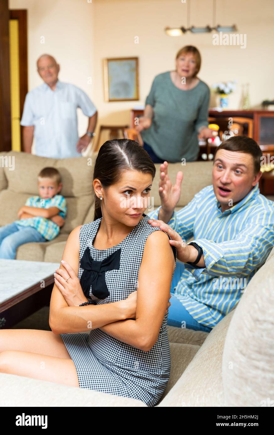 Scowling woman after quarrel with husband and parents Stock Photo - Alamy
