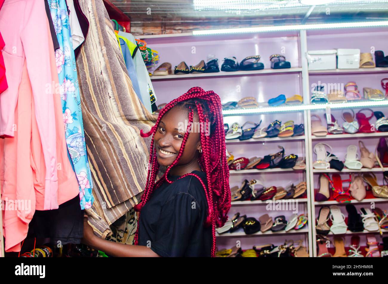 beautiful young african woman shopping for clothes in store Stock Photo ...