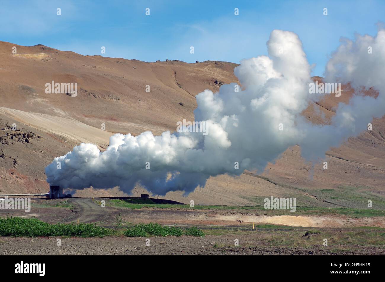 Plumes of steam hiss from a pipe, volcanic landscape, geothermal energy ...