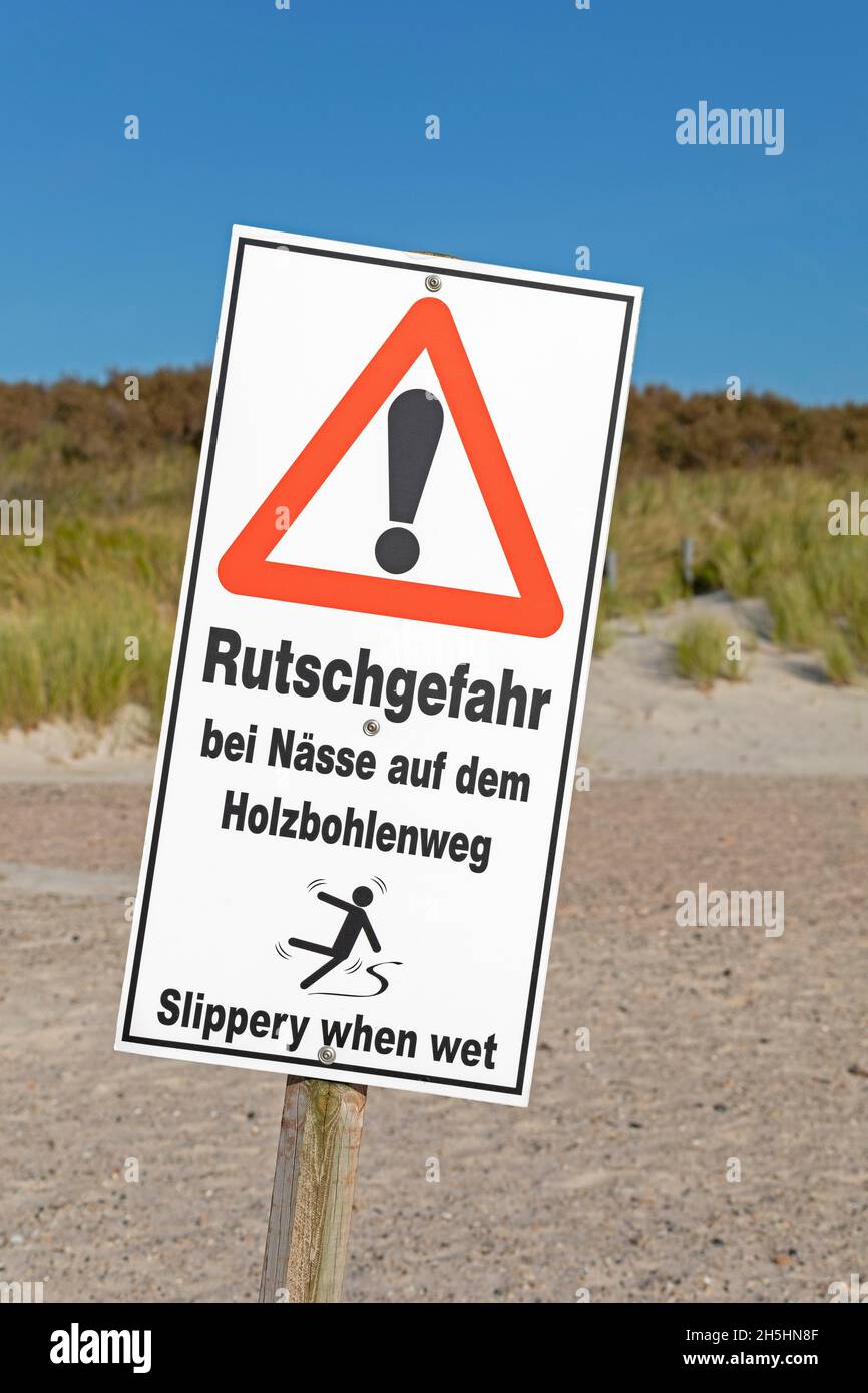 Sign warning of danger of slipping on the wooden plank path when wet ...