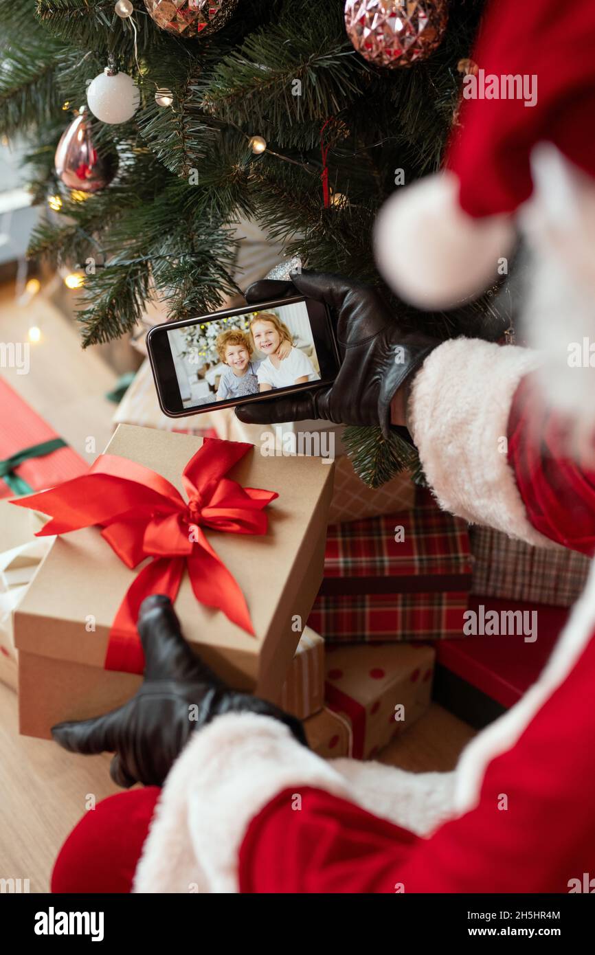 Over shoulder view of unrecognizable Santa Claus in black gloves ...
