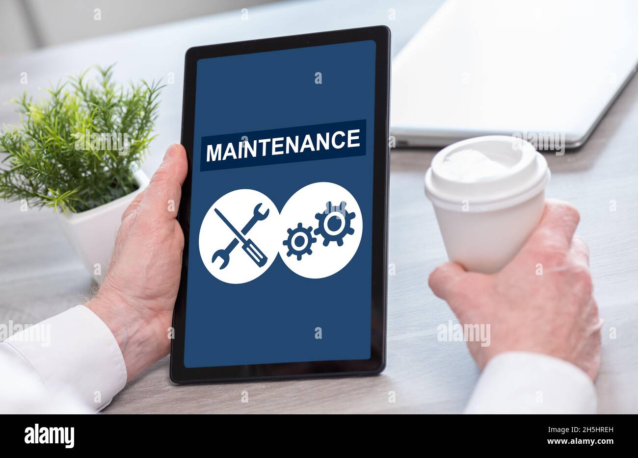 Tablet screen displaying a maintenance service concept Stock Photo - Alamy