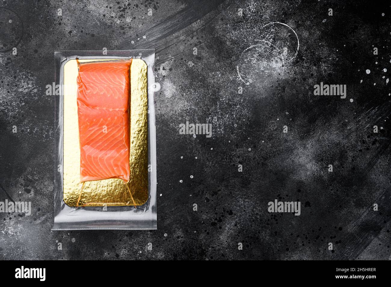 Salmon fillet vacuum pack fish meat set, on black dark stone table ...