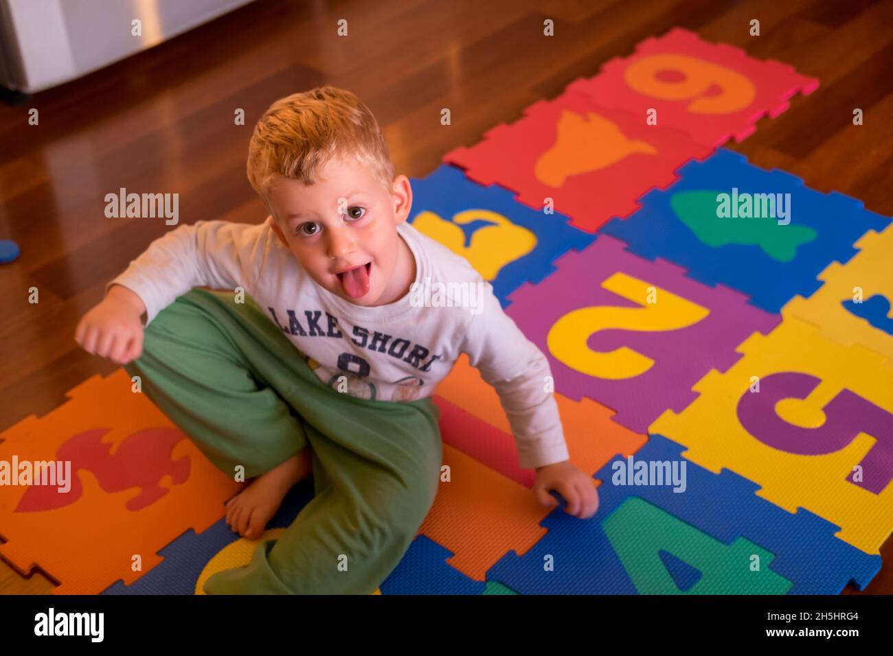 Cute creative and curious little boy playing with his toy's Stock Photo ...
