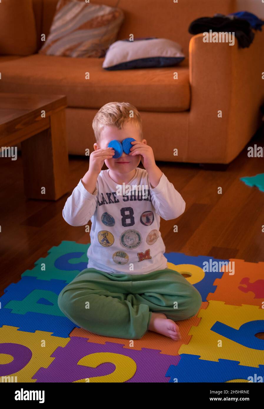 Cute creative and curious little boy playing with his toy's Stock Photo ...