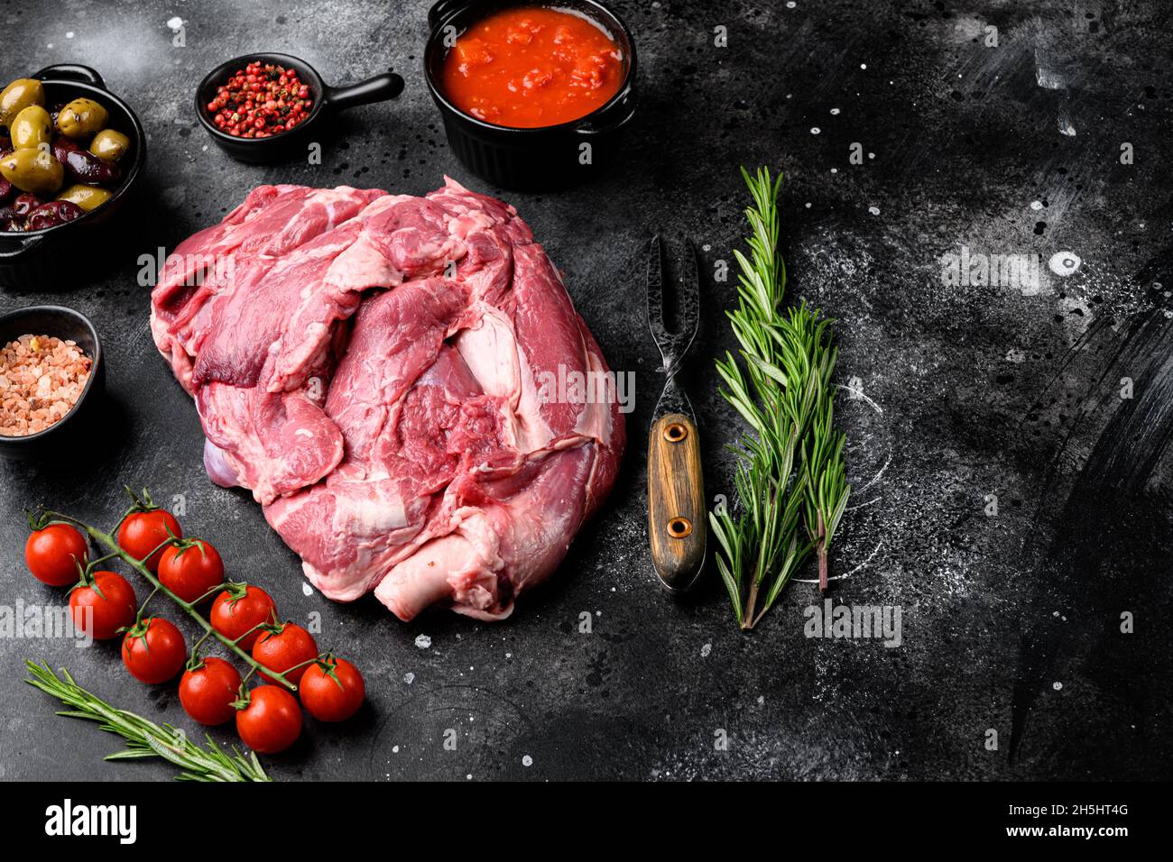 Raw lamb shoulder meat ready for baking set, with ingredients and herbs ...