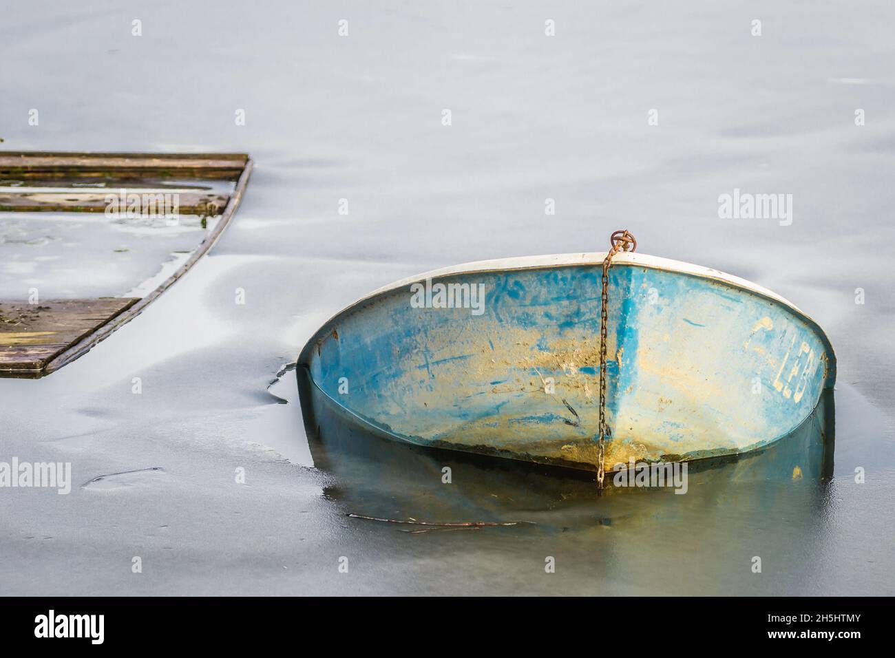 Submerged fishing boat in frozen water Stock Photo - Alamy