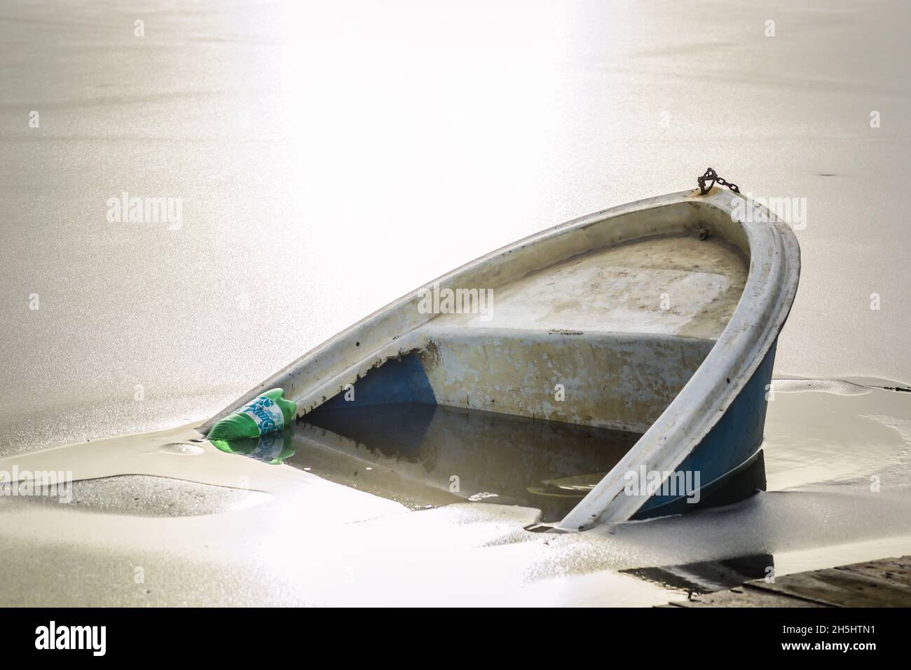 Submerged fishing boat in frozen water Stock Photo - Alamy