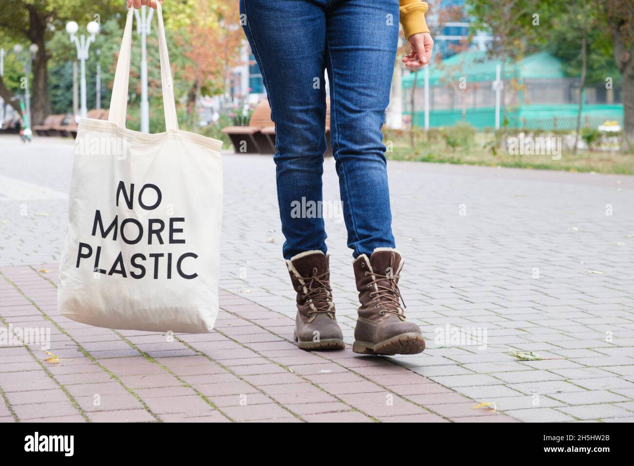 Human feet in boots and a reusable cloth bag with the inscription No ...