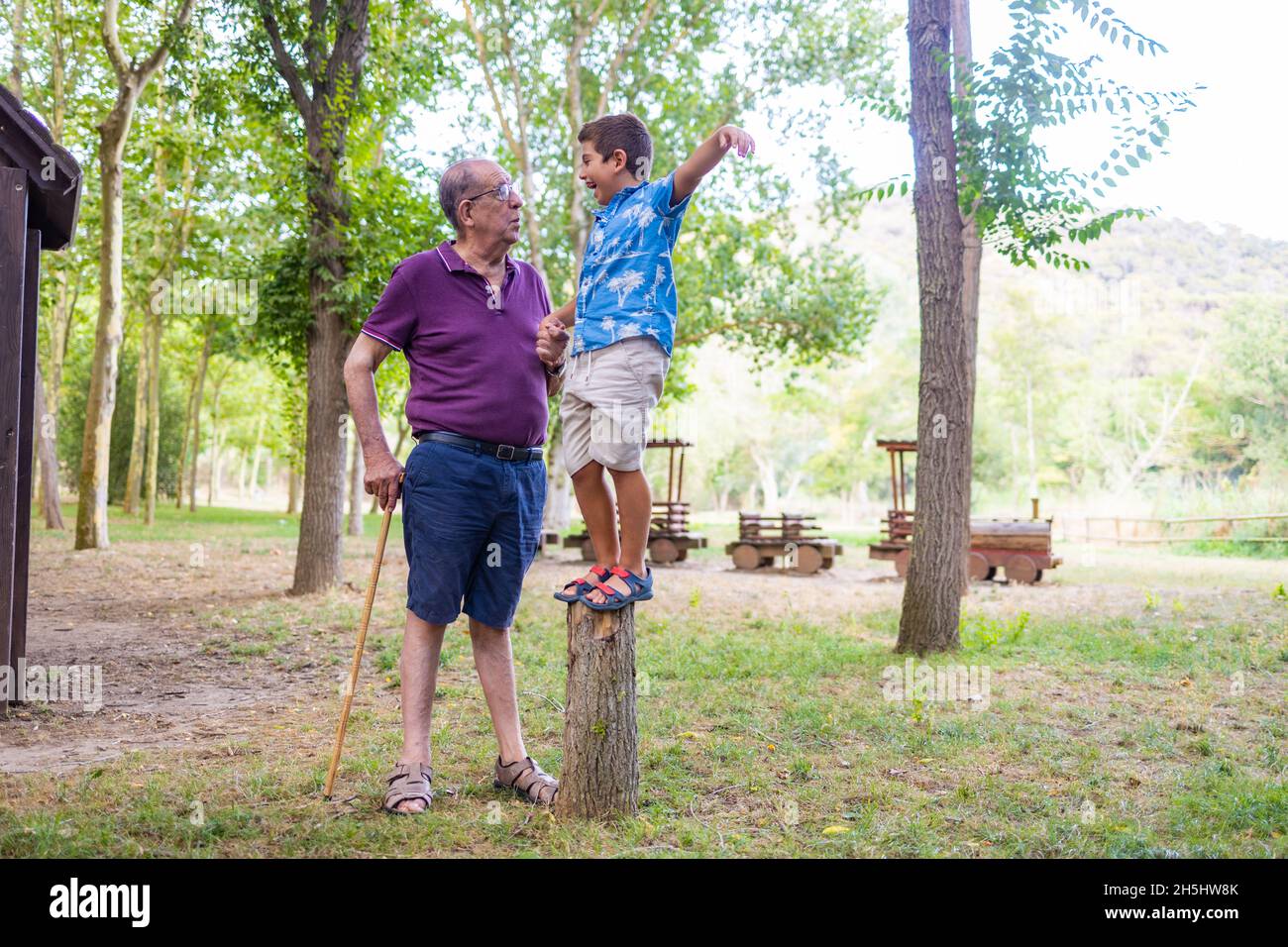 Grandfather and his grandson playing in the forest Stock Photo - Alamy