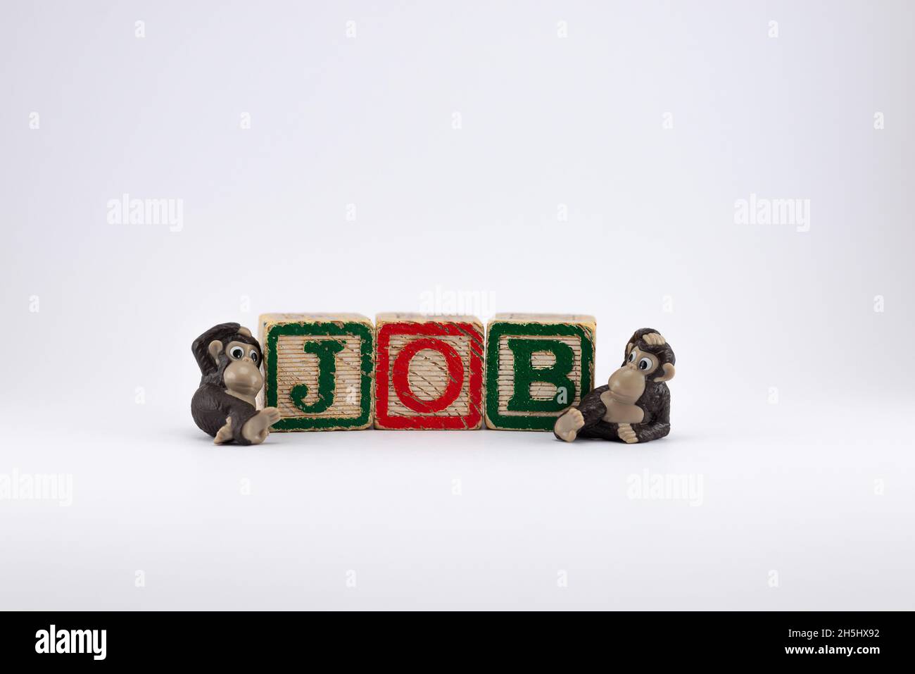 Icons of two monkeys next to wooden cubes symbolizing job on white ...