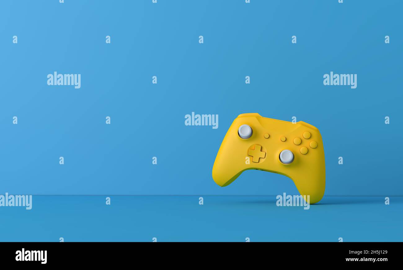 Bright yellow video game controller against a blue background. Gaming ...