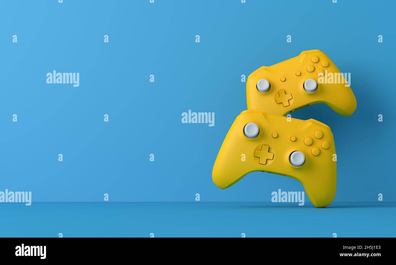 Bright yellow video game controller against a blue background. Gaming ...