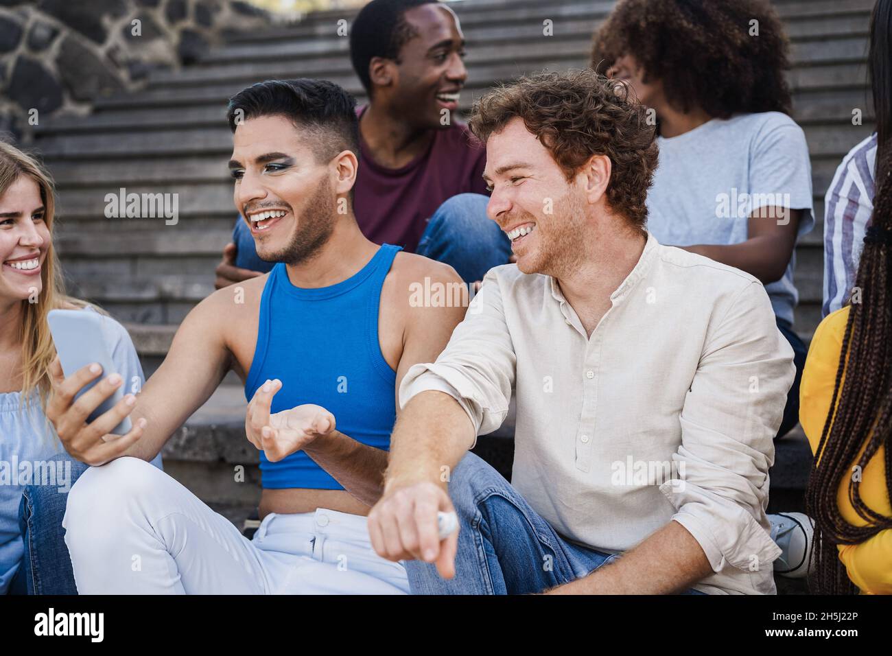 Young diverse people having fun outdoor laughing together - Focus on ...