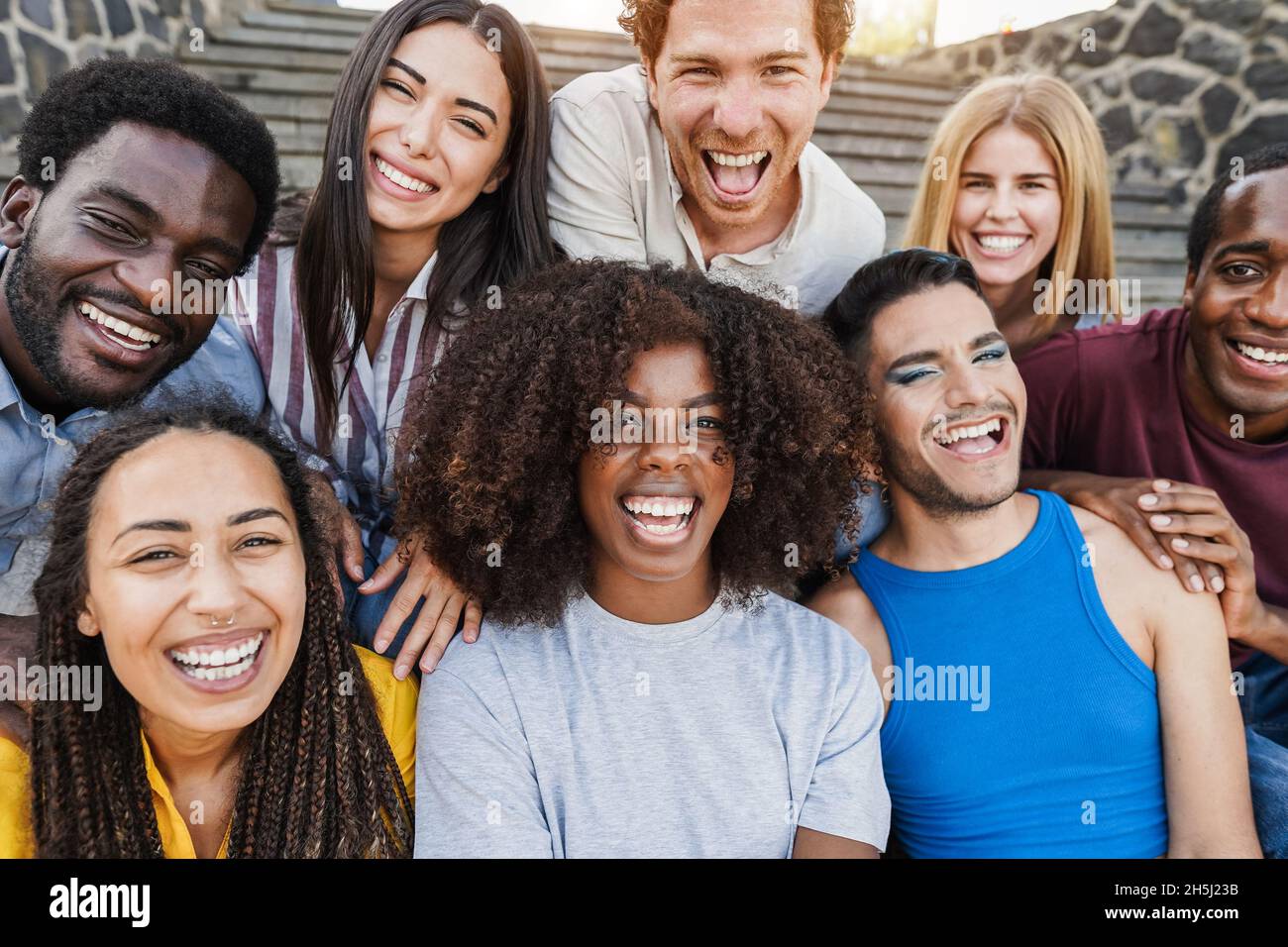 Young diverse people having fun outdoor laughing together - Focus on ...