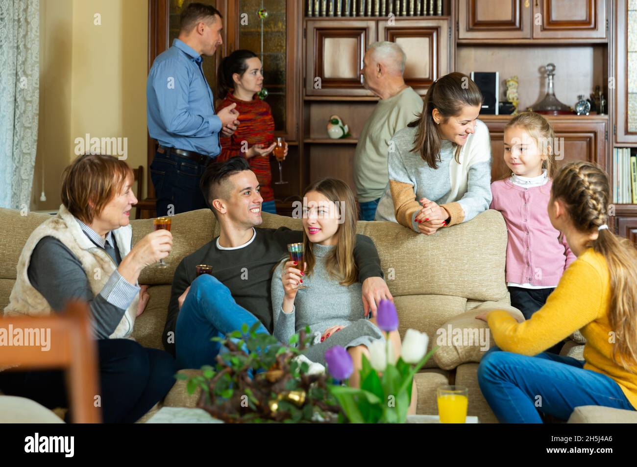 Happy family having conversation together Stock Photo - Alamy