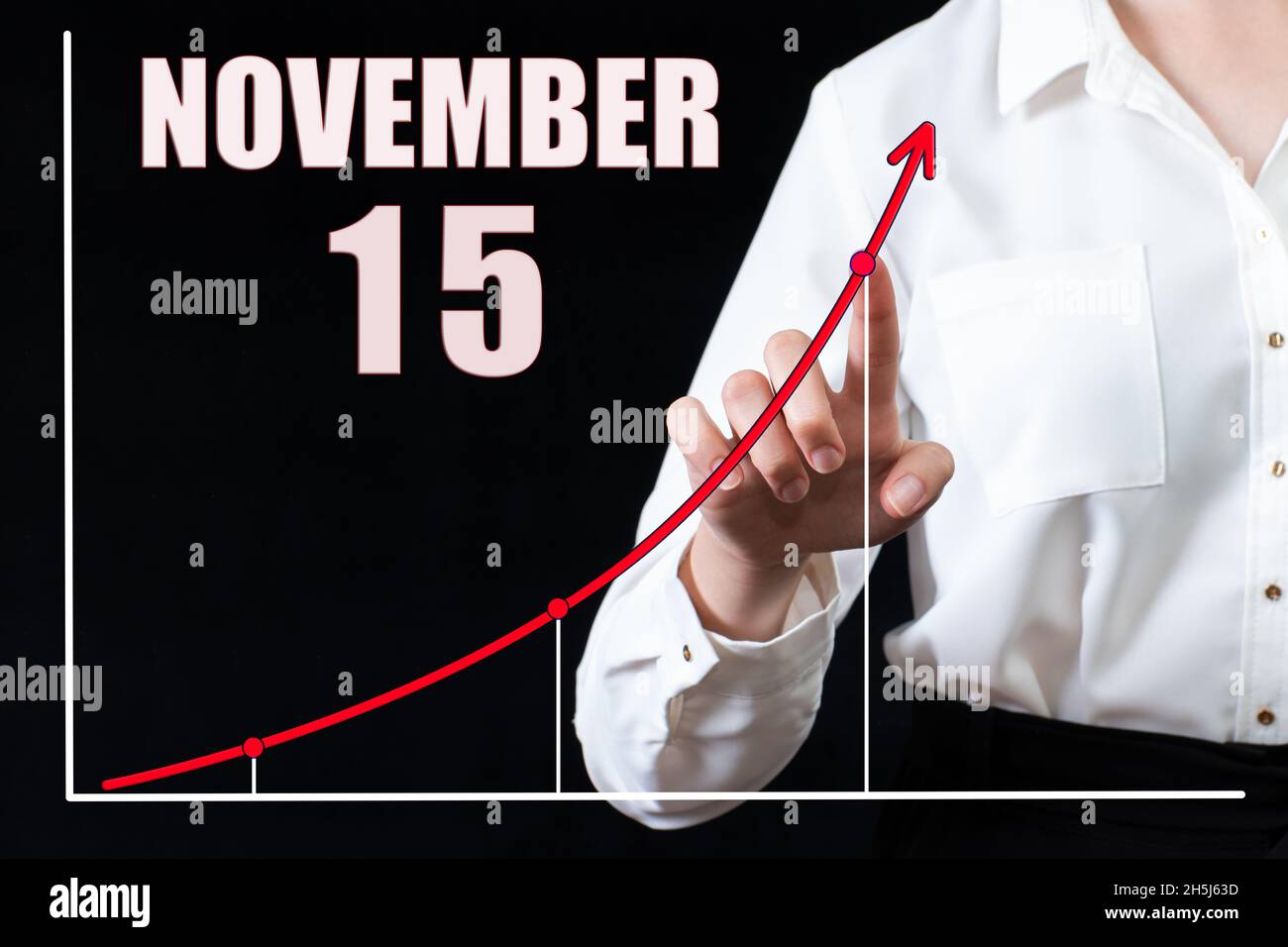 15th day of november. Businesswoman's hand pointing to the graph and a ...