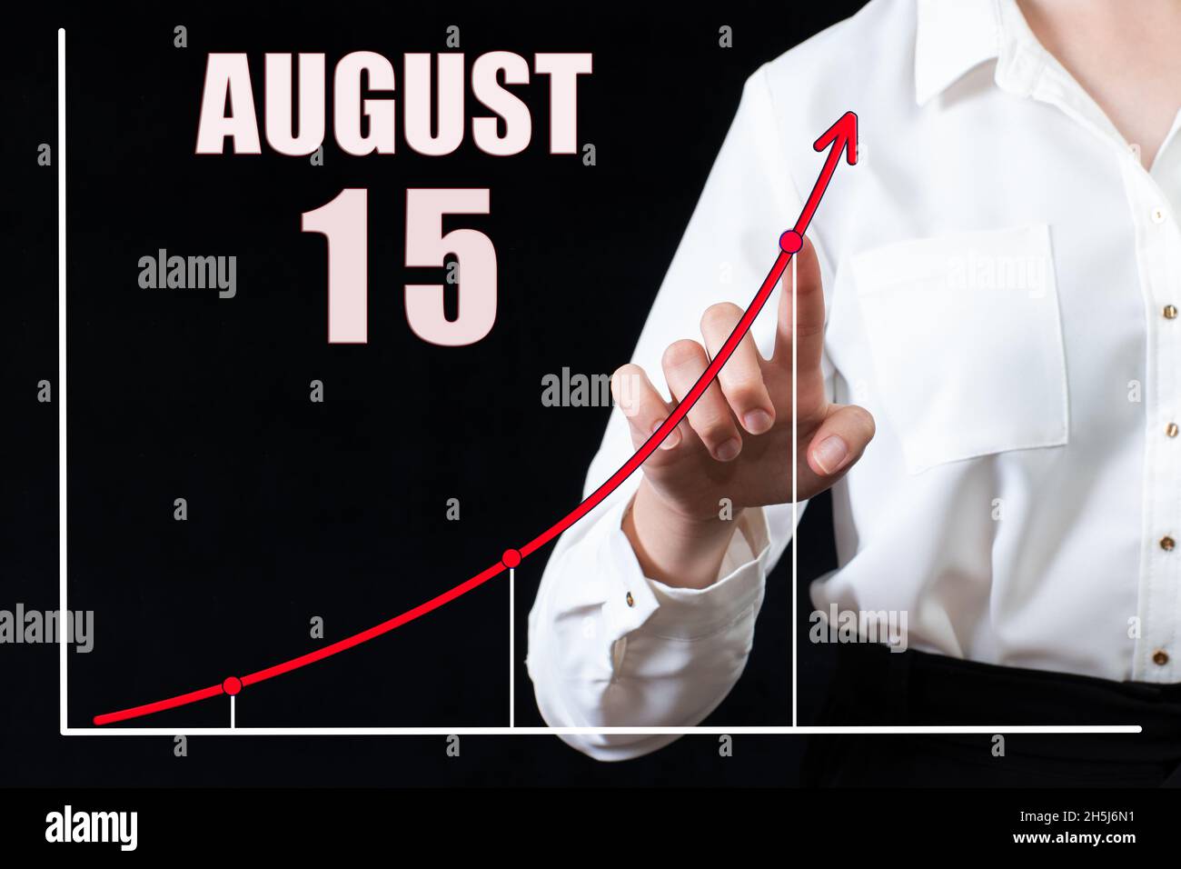 15th day of august. Businesswoman's hand pointing to the graph and a ...
