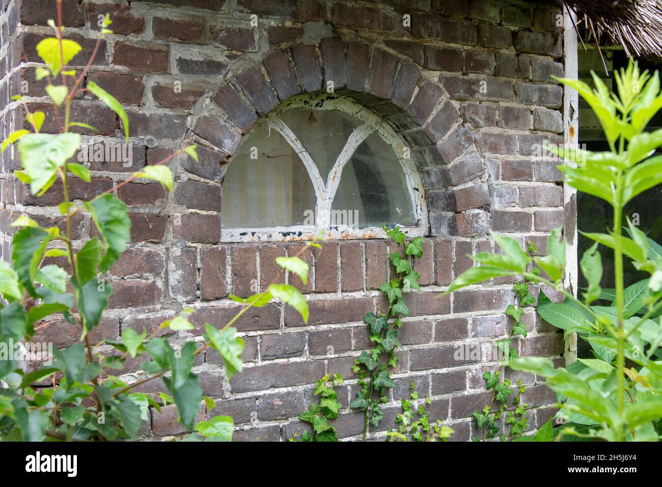 Close up view of half moon window in dilapidated and abandoned ...