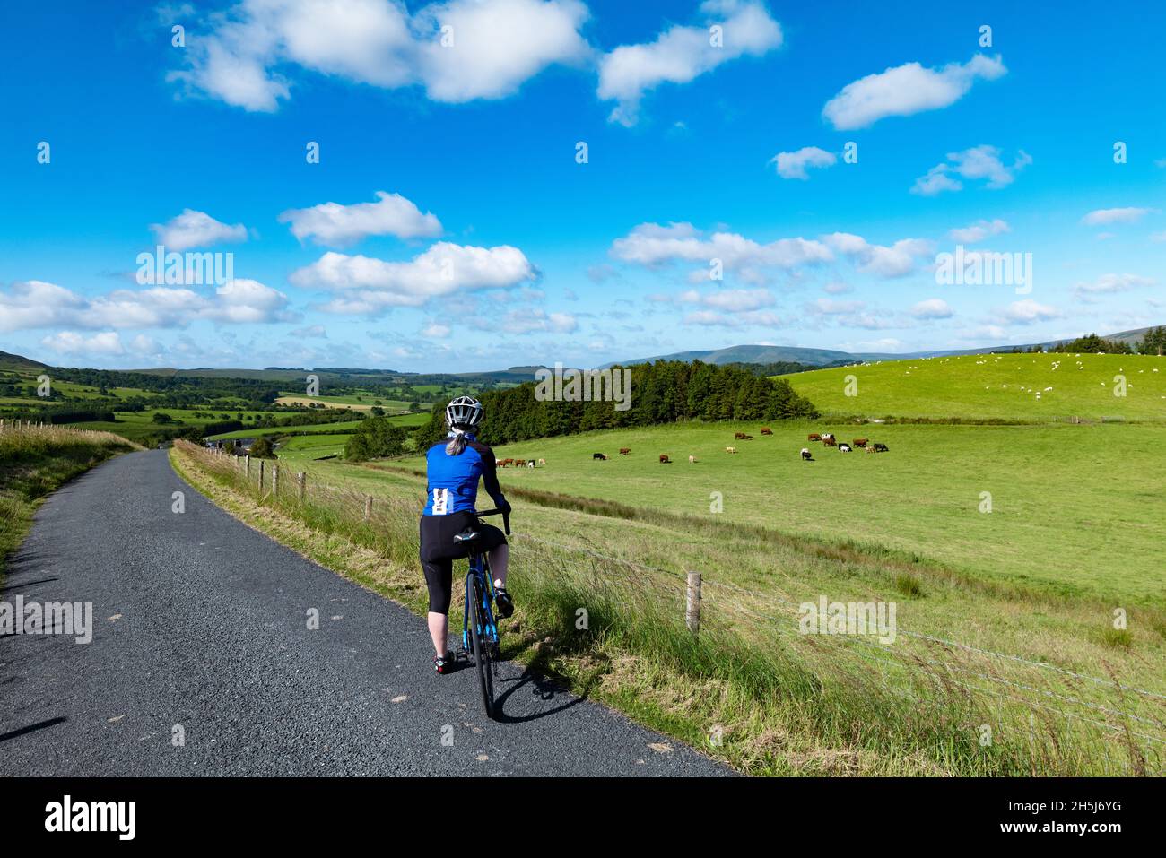 Female road cyclist on her first ride with an Electric road bike ...