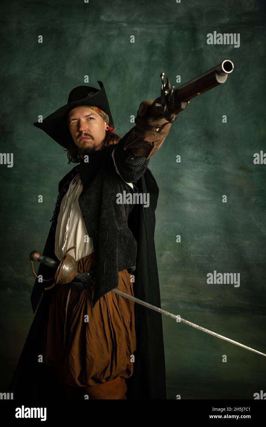 Cropped portrait of brutal frightening man, medeival pirate in vintage ...