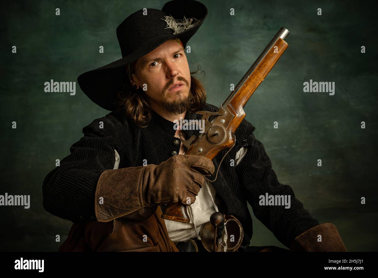Cropped portrait of brutal frightening man, medeival pirate in vintage ...
