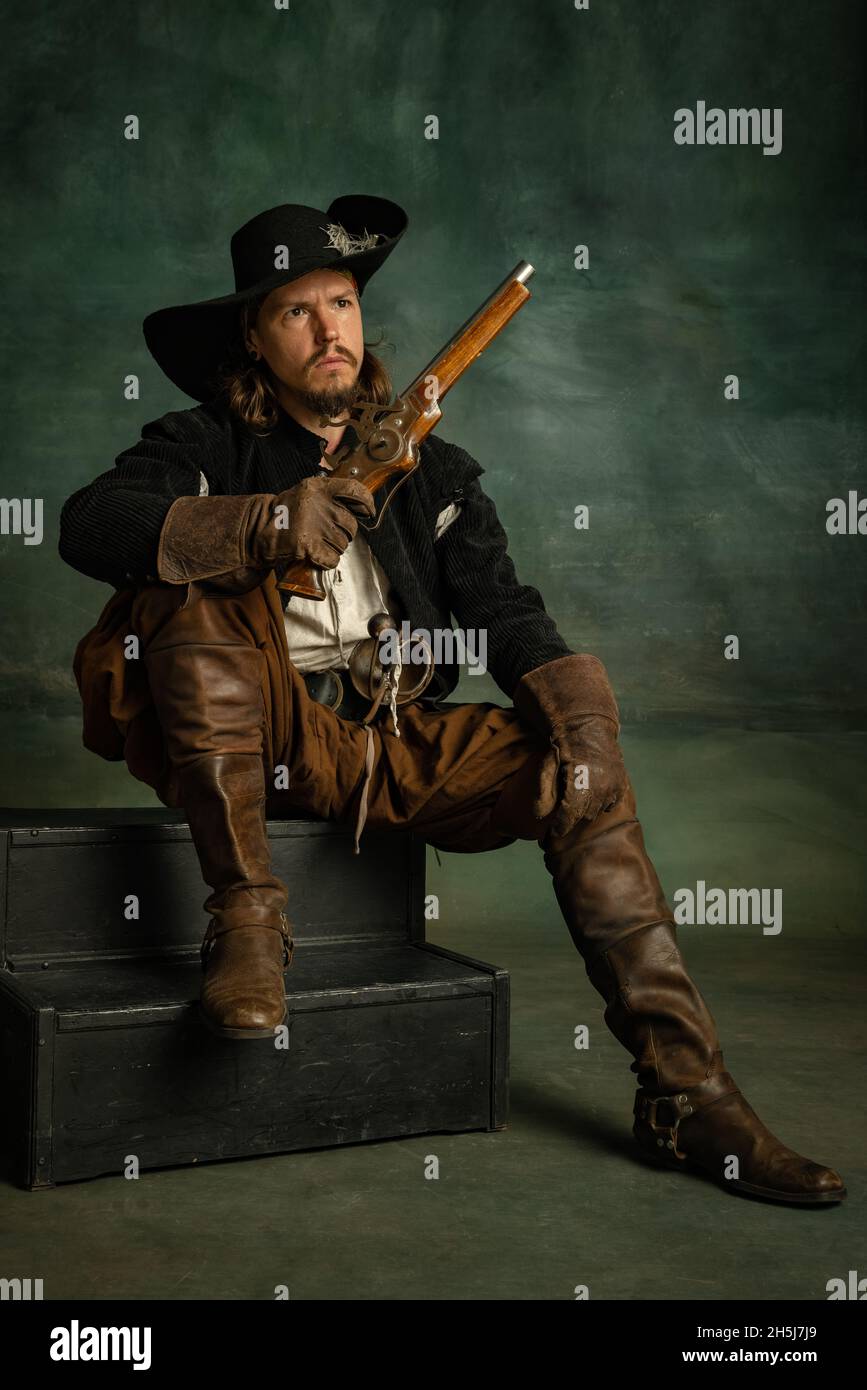 Cropped portrait of brutal frightening man, medeival pirate in vintage ...