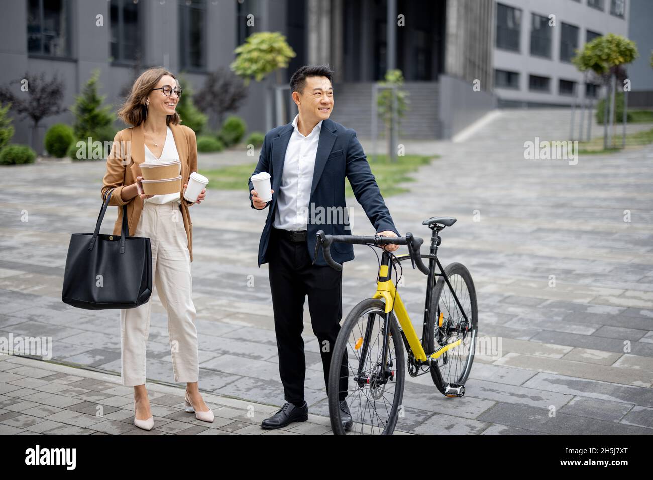 Business people walk, drink coffee and talk Stock Photo - Alamy