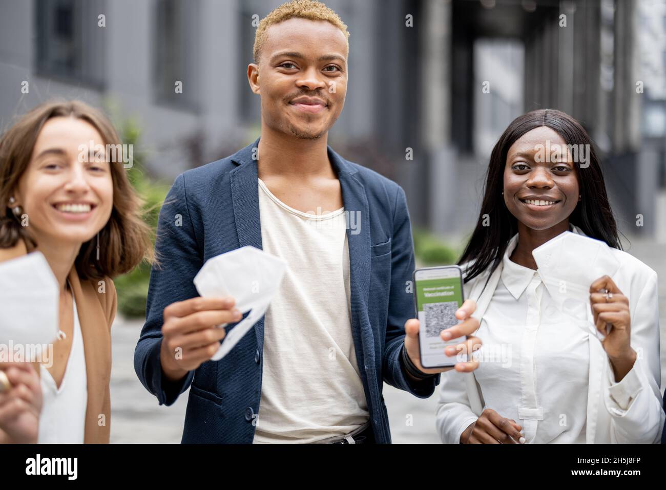 Business team taking off medical masks and talking Stock Photo - Alamy