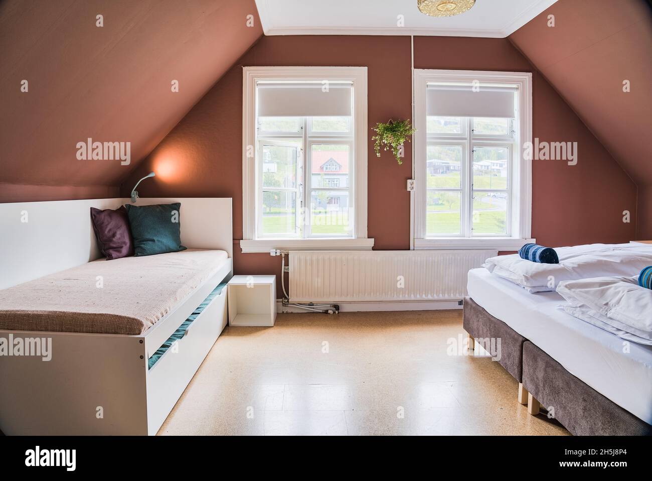 Cosy and quiet room with walls covered with warm colours and ecological ...