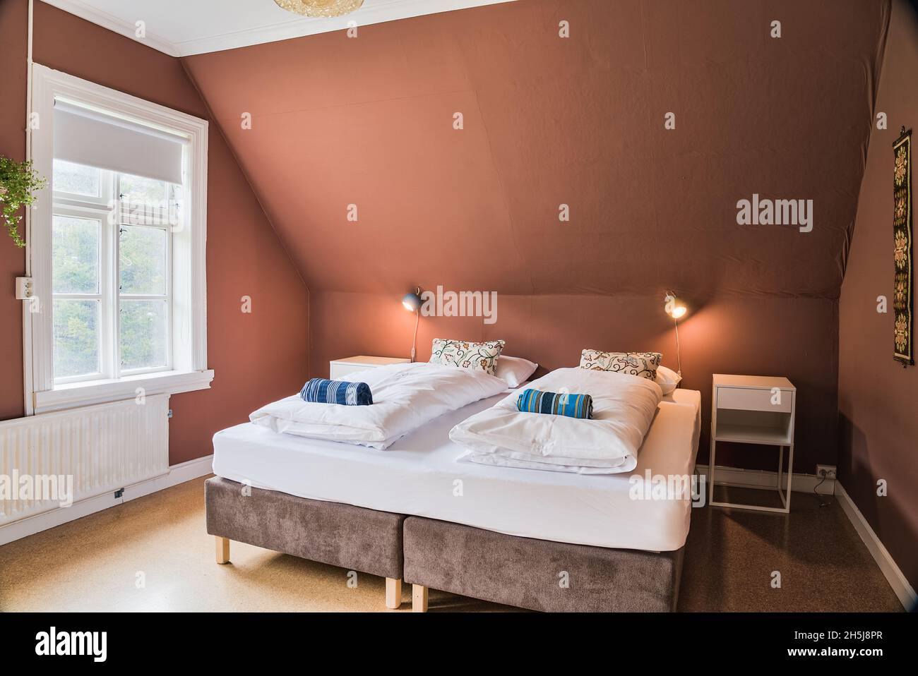 Cosy and quiet room with walls covered with warm colours and ecological ...