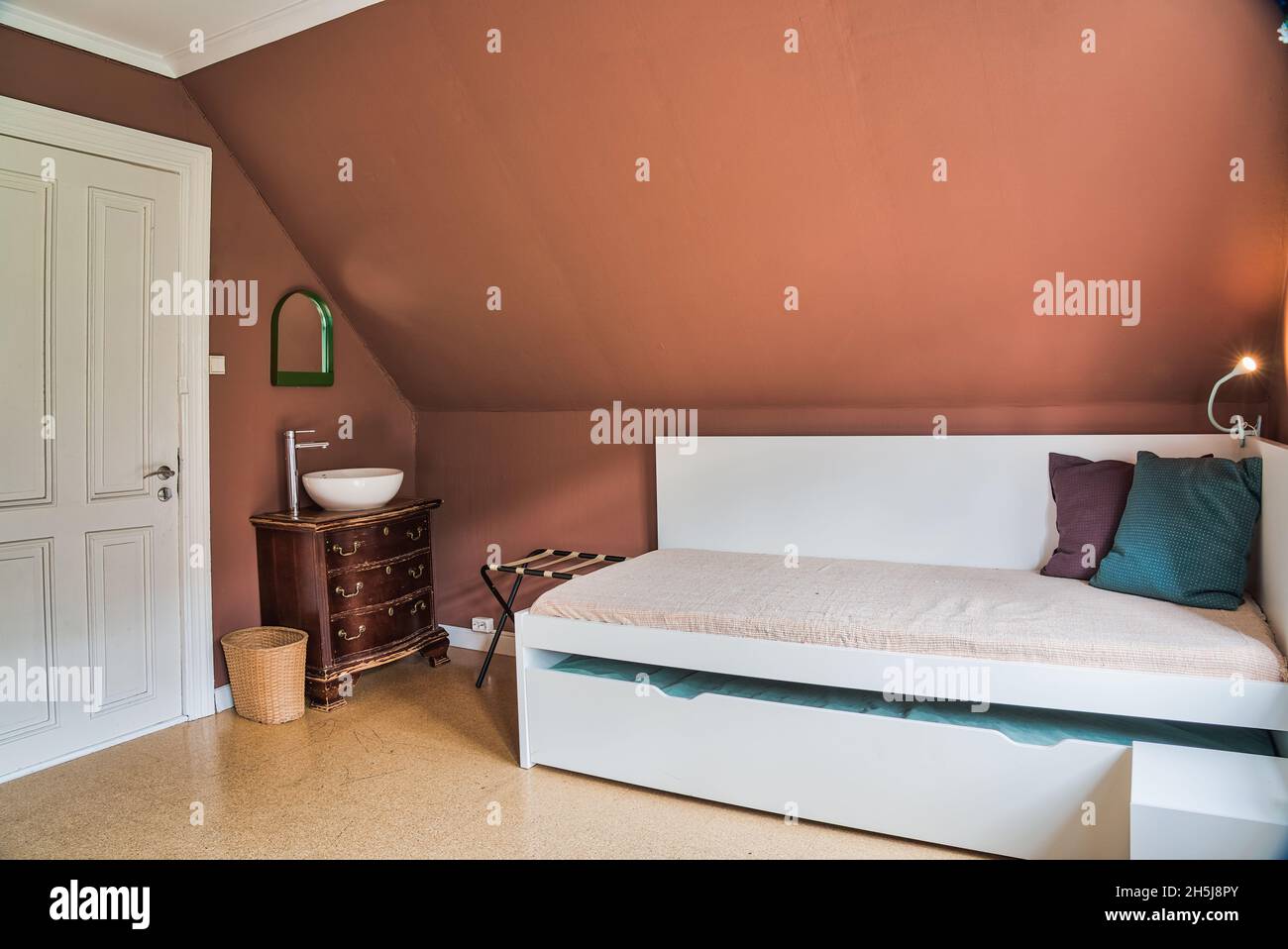 Cosy and quiet room with walls covered with warm colours and ecological ...