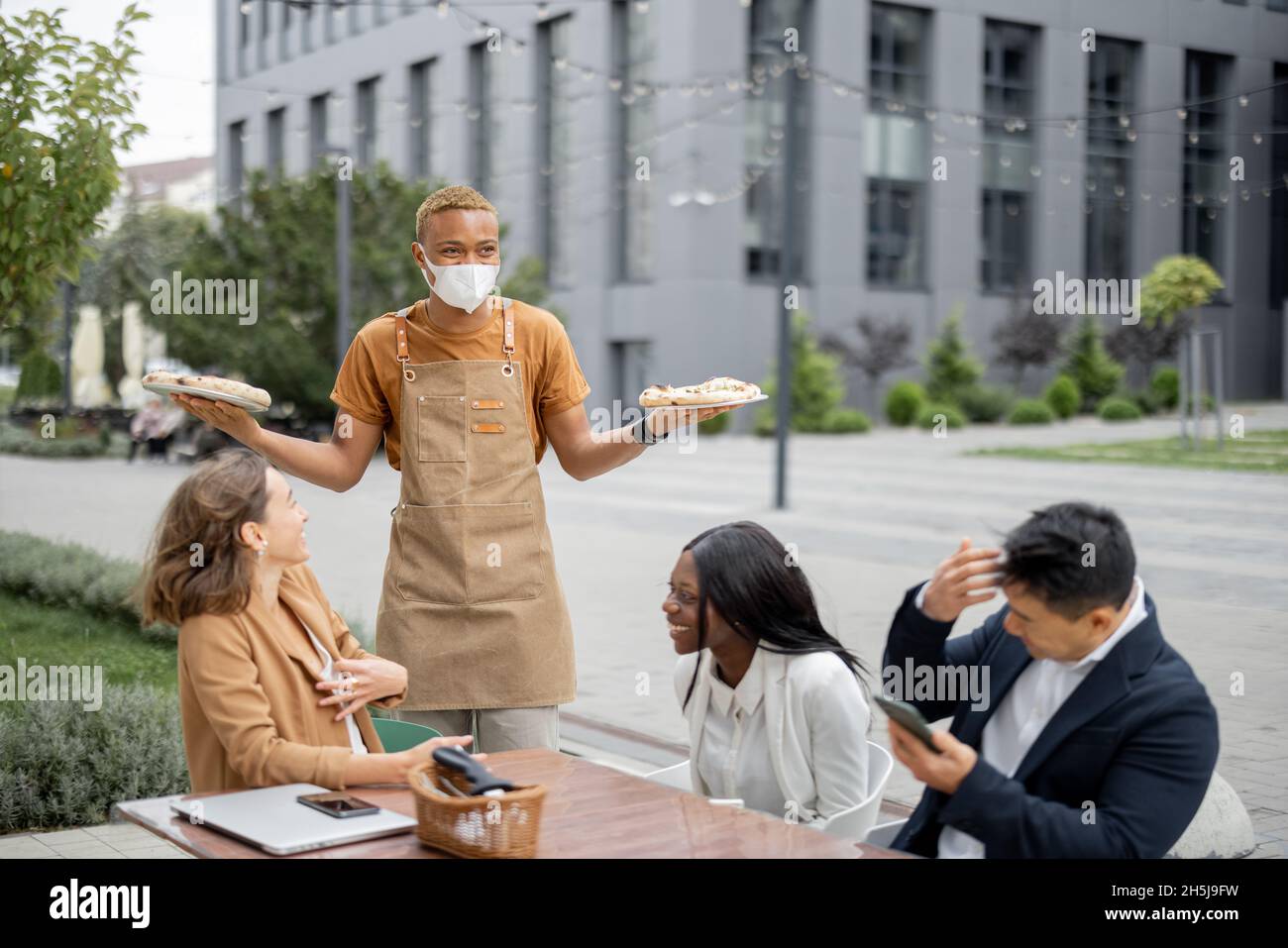 Business team having lunch at outdoor cafe Stock Photo - Alamy