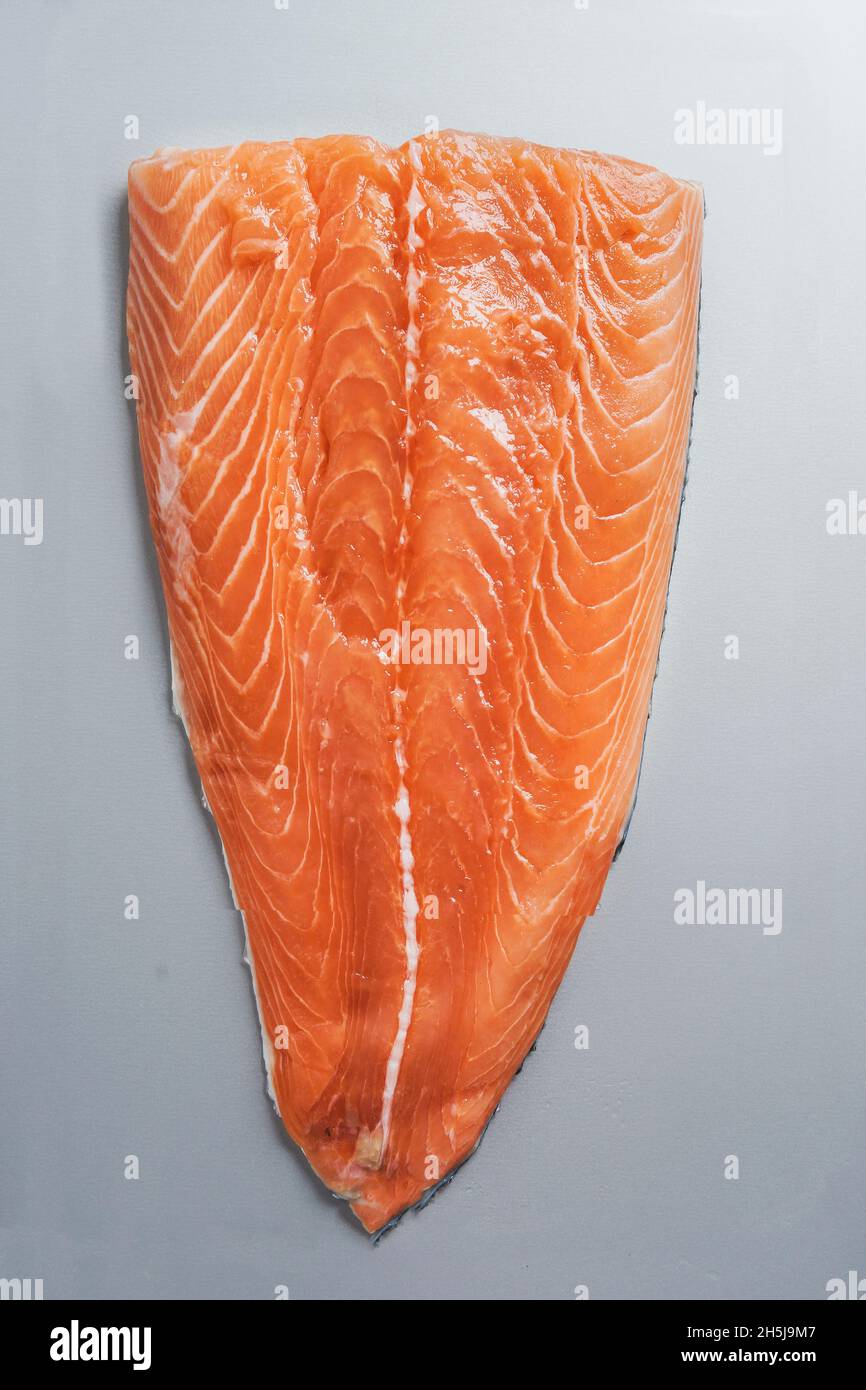 Raw salmon fillet on pale grey background. Top view Stock Photo - Alamy