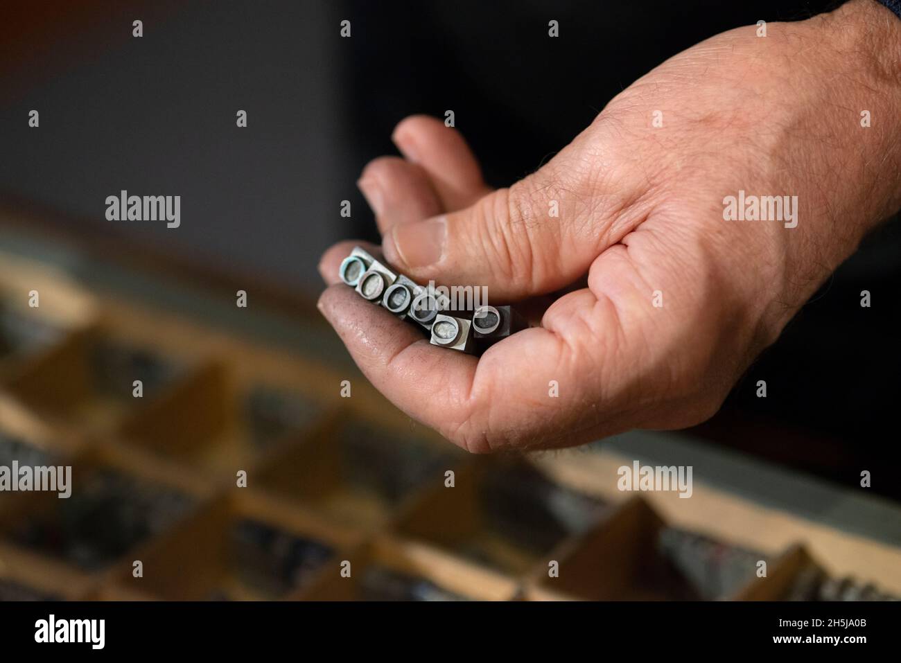Alphabet Letter Metal Blocks in Old Man Hand Stock Photo - Alamy